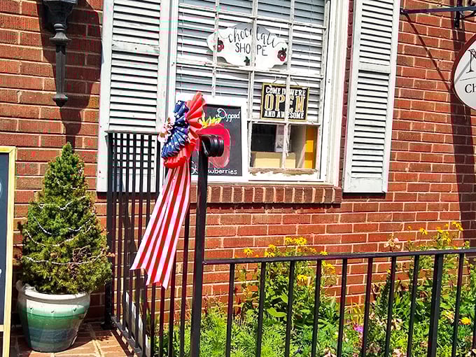 The unassuming brick storefront of NazBro Chocolates beckons with a promise that's impossible to resist: FREE FUDGE SAMPLES. Resistance is futile.