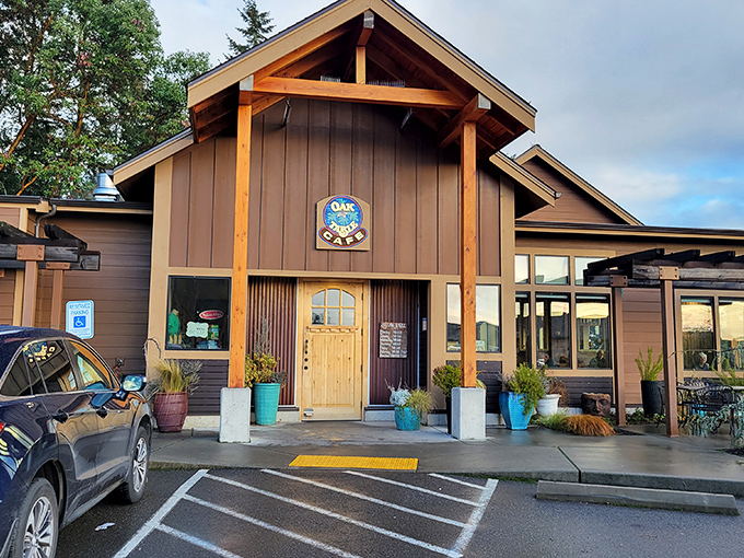 The Oak Table Cafe stands like a woodland retreat among Silverdale's evergreens, promising pancake paradise behind those timber beams.