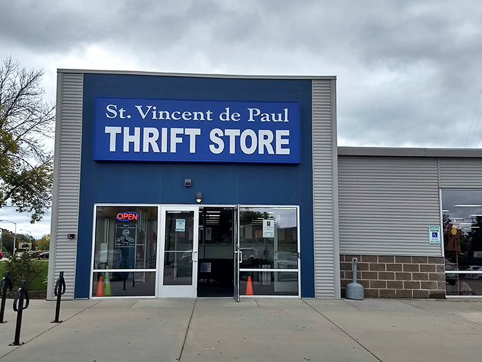 The distinctive blue facade of St. Vincent de Paul stands like a beacon for bargain hunters on Odana Road, promising treasures within. 
