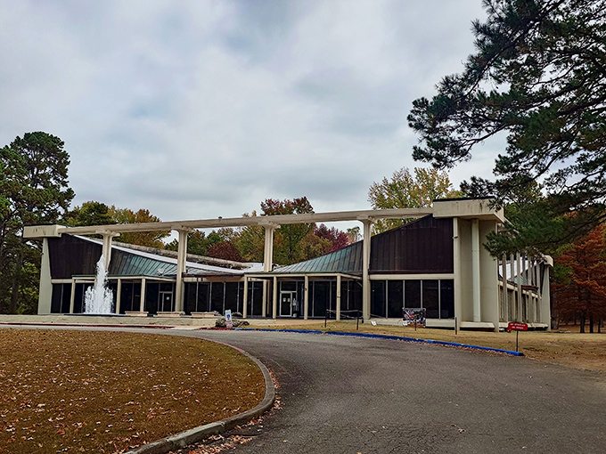 The modernist architecture of the Museum of Automobiles stands like a mid-century time capsule against Arkansas's lush greenery, complete with a welcoming fountain.