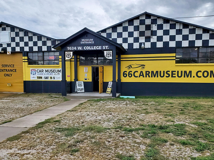The classic checkered flag meets sunshine yellow on this roadside gem. A fitting beacon for automotive aficionados traveling along the Mother Road.