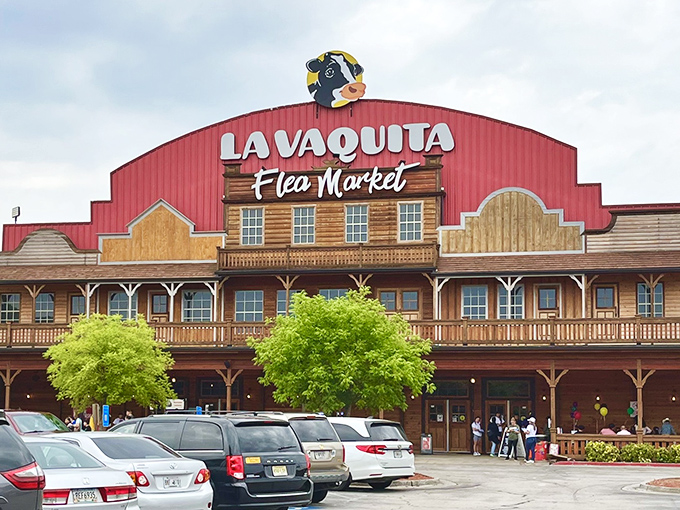 The iconic red-roofed facade of La Vaquita welcomes treasure hunters with its Western-style porch and watchful cartoon cow mascot overhead.