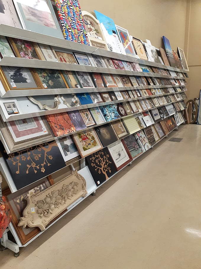 The wall of framed art offers everything from serene landscapes to quirky abstracts&mdash;each piece waiting to find its forever wall.