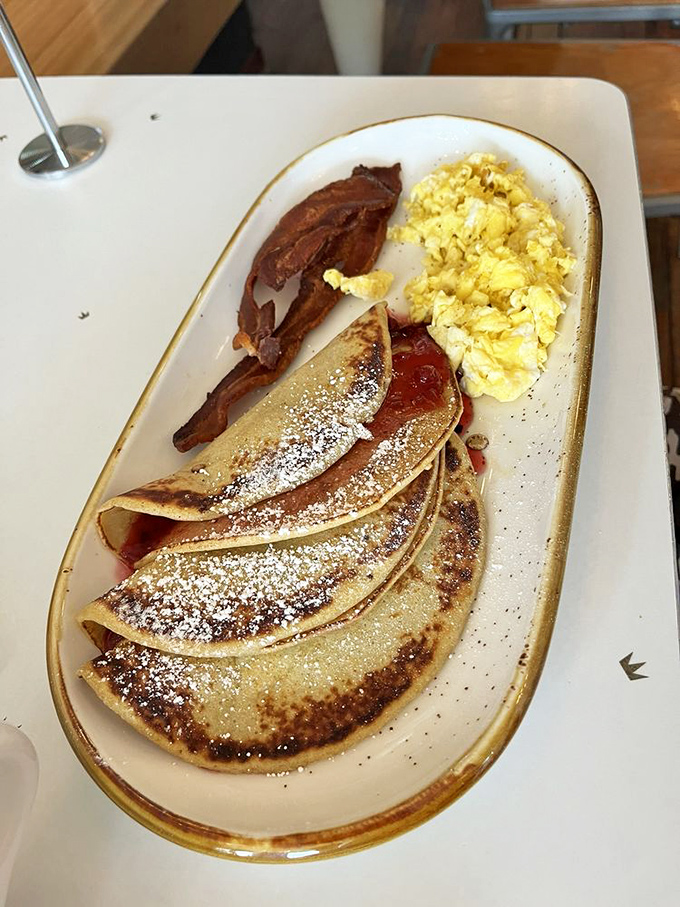 Swedish pancakes so elegantly thin they make regular pancakes feel overdressed, served with a dusting of powdered sugar magic.