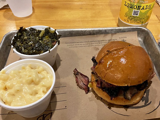 This brisket sandwich, flanked by mac and cheese and collards, is what would happen if comfort food went to graduate school.