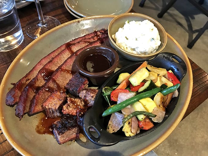 Brisket sliced to perfection with seasonal vegetables and potato salad&mdash;a plate that would make a vegetarian seriously reconsider their life choices.