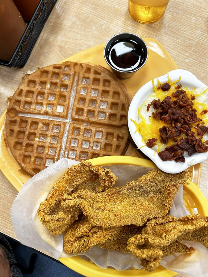 A waffle, catfish, and cheese-topped grits create the kind of breakfast trifecta that makes hitting the snooze button a criminal offense.