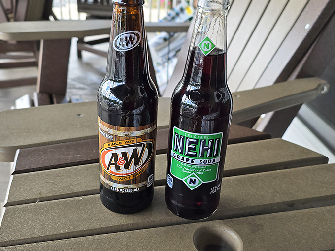 The classic soda duo: A&W and Nehi, standing at attention on a porch table. Nostalgia in glass bottles.