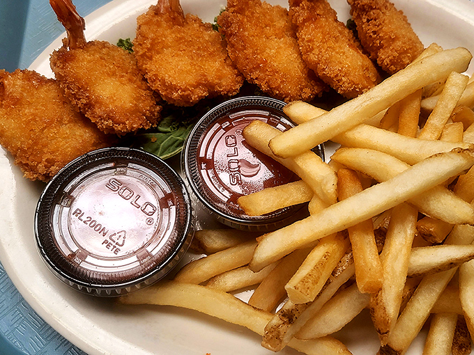 These golden shrimp and fries aren't just food&mdash;they're edible sunshine on a plate with dipping sauces for clouds.