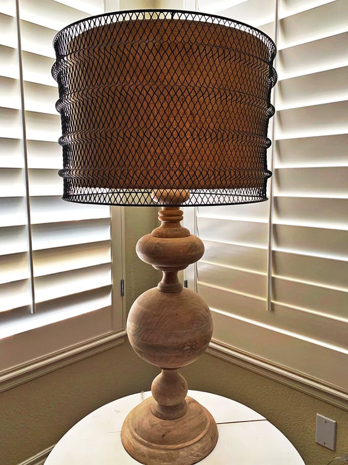 This wooden lamp with its mesh shade isn't just lighting&mdash;it's a conversation piece that whispers "sophisticated farmhouse."