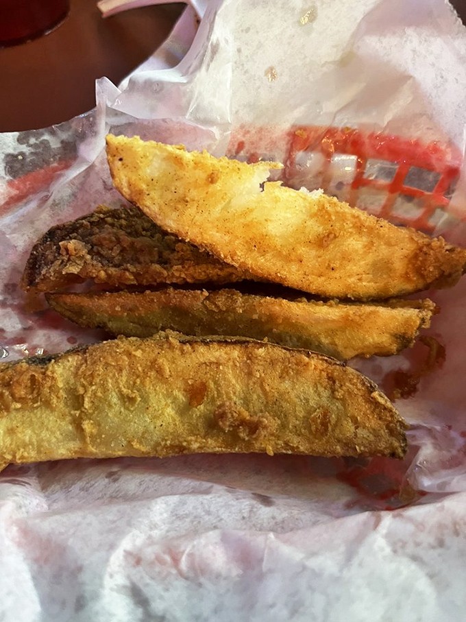 Potato wedges that achieve the impossible: crispy exteriors giving way to fluffy interiors, seasoned just right for maximum potato pleasure.