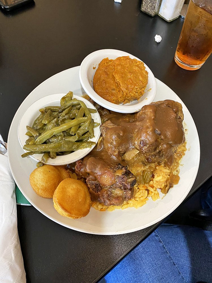 Slow-braised oxtails swimming in rich gravy with green beans and what might be carrot souffl&eacute;. This isn't just food&mdash;it's an event worth clearing your schedule for.