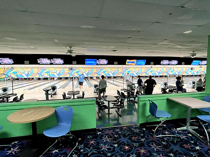 The tiered seating area offers the perfect vantage point to cheer on friends or strategize your approach to conquering that stubborn 7-10 split.