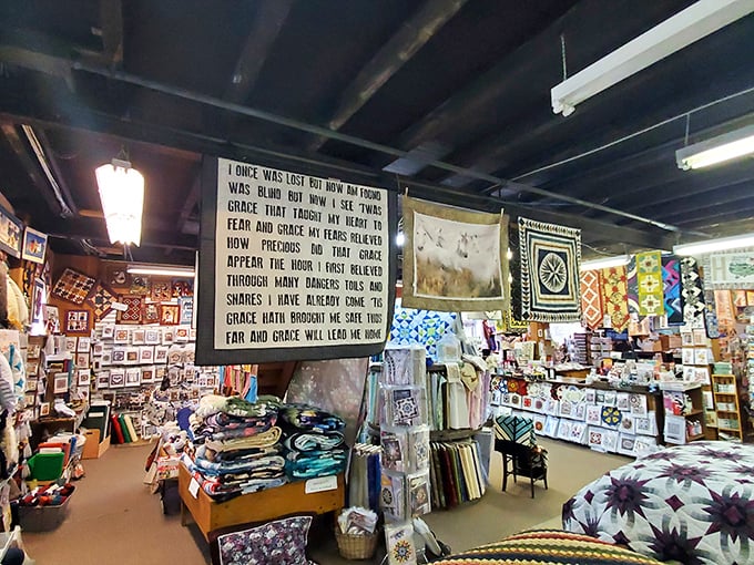 The lyrics to "Amazing Grace" preside over this corner of the shop, where stacks of fabric await transformation into heirloom quilts.