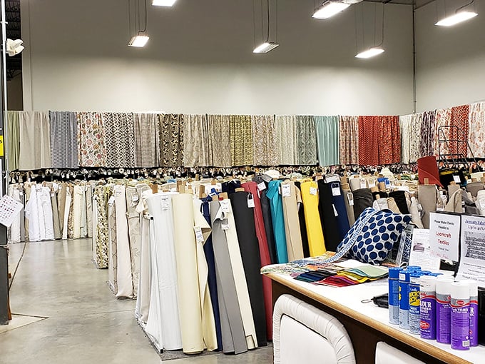 A rainbow of possibilities arranged with military precision. This is what organization looks like when fabric lovers are in charge.