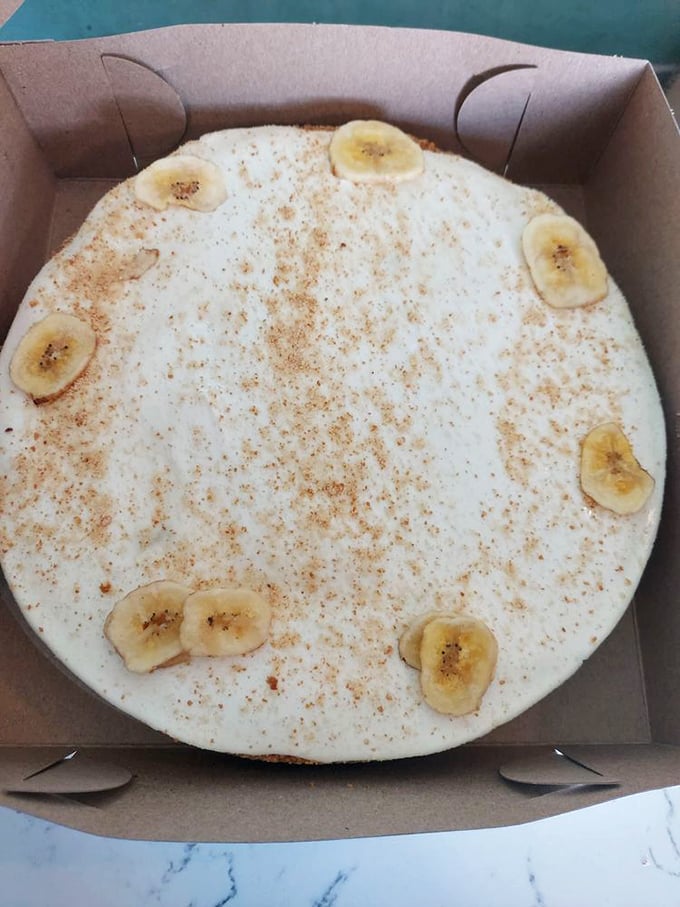 Banana slices standing like sentinels guarding the creamy kingdom below. This isn't just banana pudding cheesecake &ndash; it's tropical treasure.