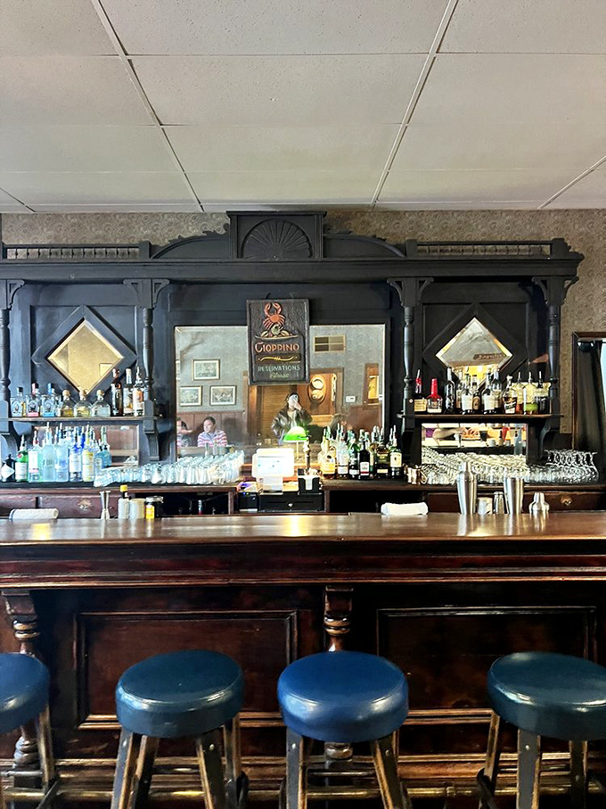 The vintage bar could star in a film noir, with its dark wood, mirrored backdrop, and the promise of stories shared over perfectly mixed drinks.