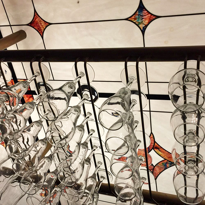 Wine glasses hanging like crystal stalactites&mdash;ready to be filled with something red and robust enough to stand up to a serious steak.