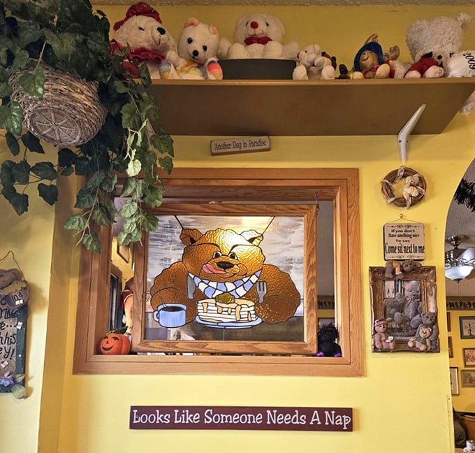 Stained glass bear enjoying pancakes watches over diners like a patron saint of breakfast. The sign below speaks universal truth about nap needs.