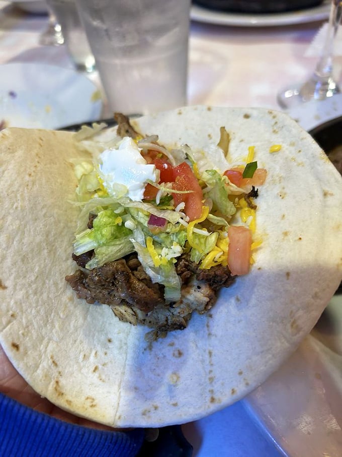 This isn't just a fajita—it's a tortilla treasure chest overflowing with seasoned meat, fresh veggies, and the promise of delicious mess.