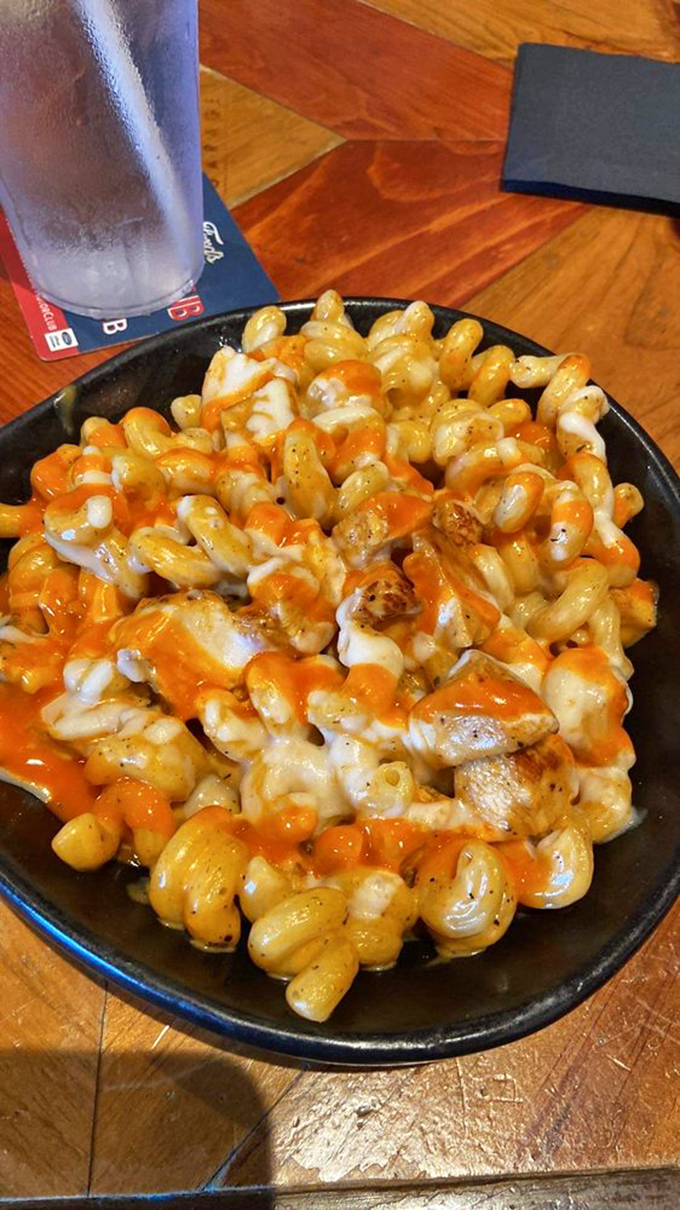 Mac and cheese gets the royal treatment with buffalo chicken and a blanket of melted cheese. Comfort food that's had a glow-up worthy of a classic car restoration.
