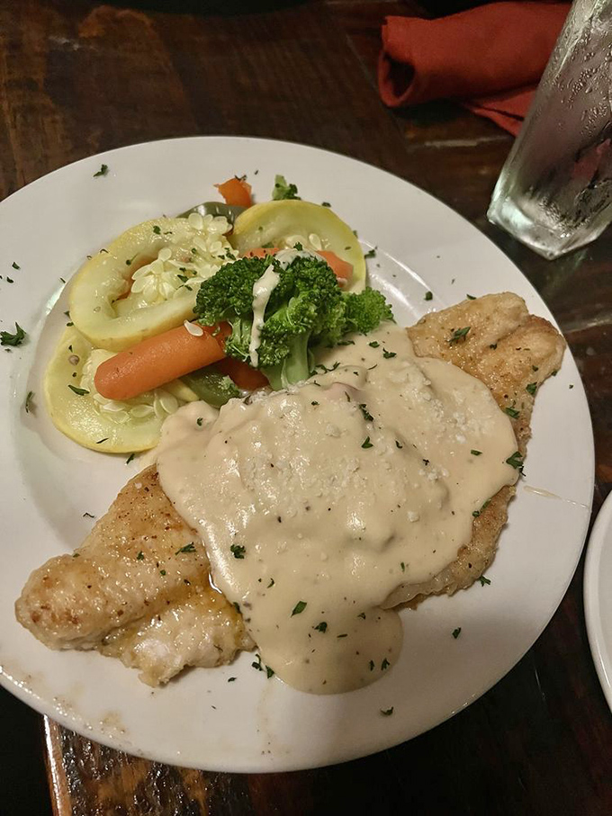 Farm-raised catfish wearing a formal coat of seasoning and swimming in sauce&mdash;it's dressed up more elegantly than I am, and with better taste.