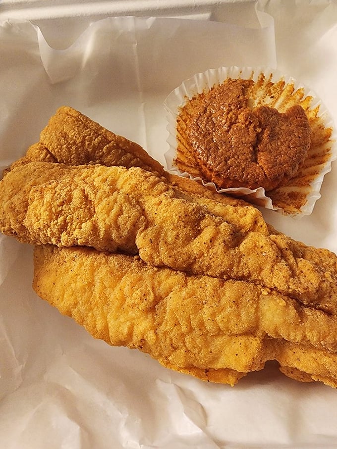 Catfish that's traveled from water to plate with nothing but respect, accompanied by a cornbread muffin that deserves its own fan club.