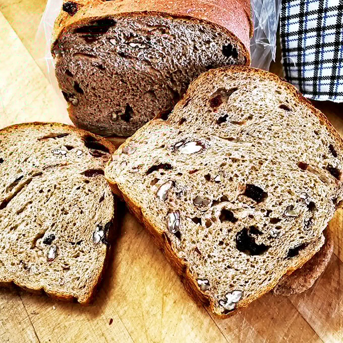 Every slice tells a story of cinnamon, pecans, and cranberries dancing together in perfect harmony within a wholesome wheat embrace.