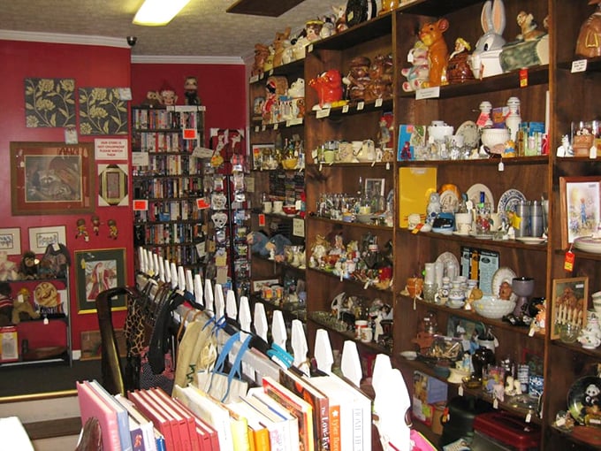 A wonderland of ceramic characters watches from every shelf, an audience of glazed eyes witnessing your treasure hunt.