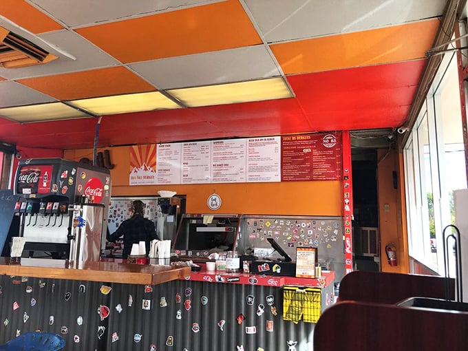 At the counter, stickers and memorabilia accumulate like badges of honor, telling the story of a beloved local spot that values personality over polish.