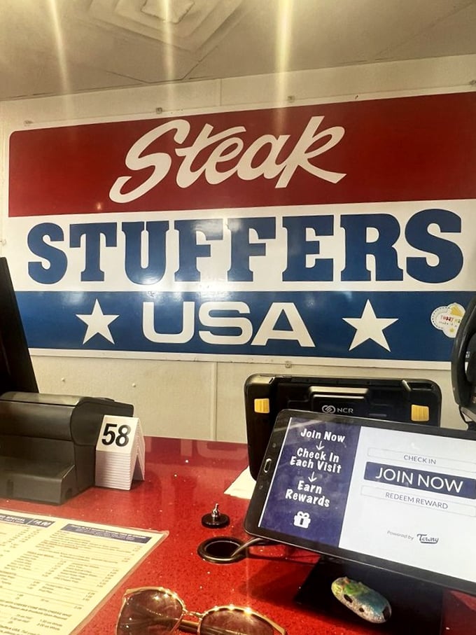 The counter where dreams come true and orders are called. That red surface has witnessed countless moments of sandwich anticipation.