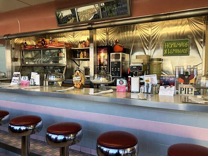 Chrome stools lined up like soldiers guarding the counter, ready for the next shift of hungry patrons seeking comfort and conversation.
