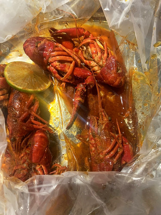 Crawfish in their plastic-bag glory, swimming in seasoned butter sauce. The most delicious little crustaceans you'll ever work for.