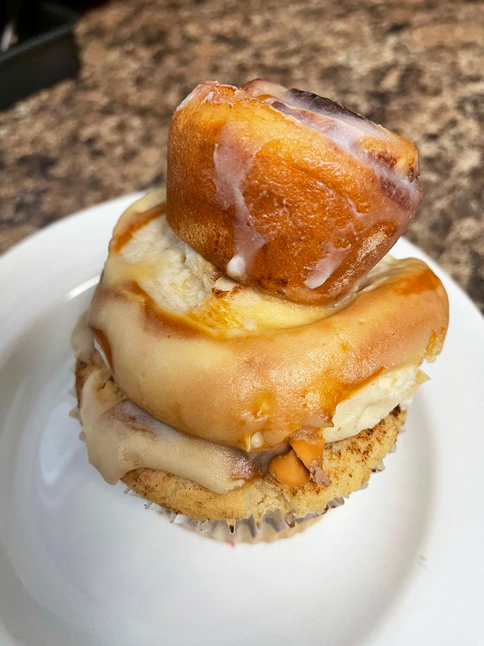 Architecture of indulgence: a cupcake topped with a mini cinnamon roll. It's dessert inception, and we're here for every layer.