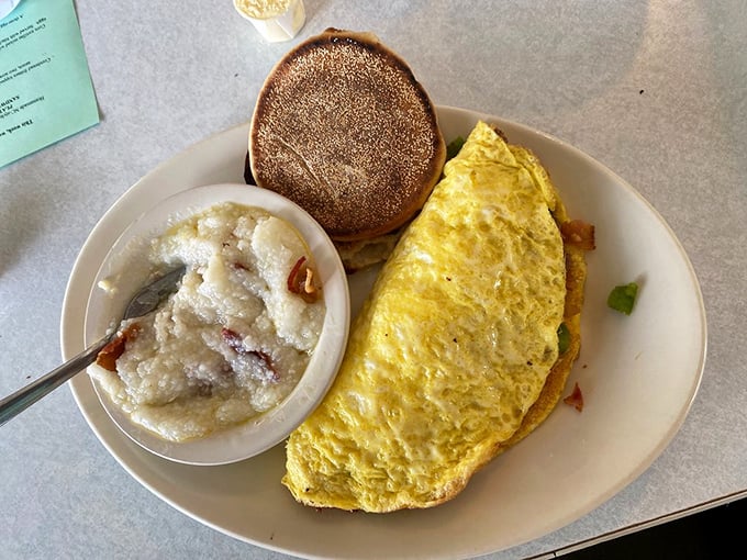 This omelet isn't just fluffy, it's practically floating, while those cheese-laced grits whisper, "Take your time, we're worth savoring."