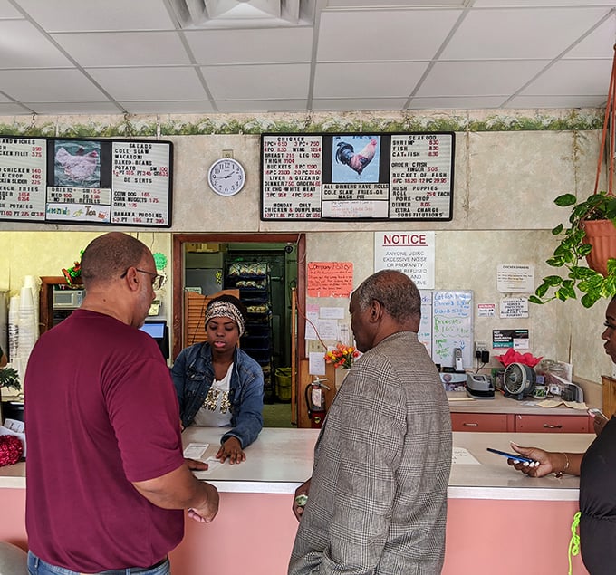 At the counter, regulars and first-timers stand shoulder to shoulder, united by the universal language of anticipation for exceptional fried chicken.