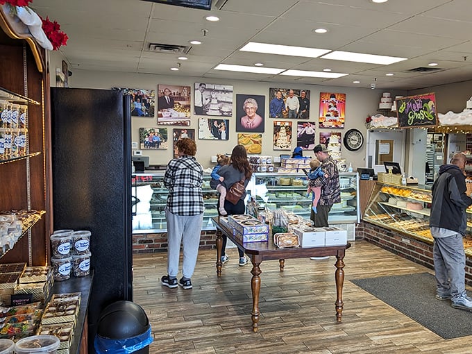 The wall of family photos watches over customers making their selections—a reminder that behind every great bakery is generations of passion.