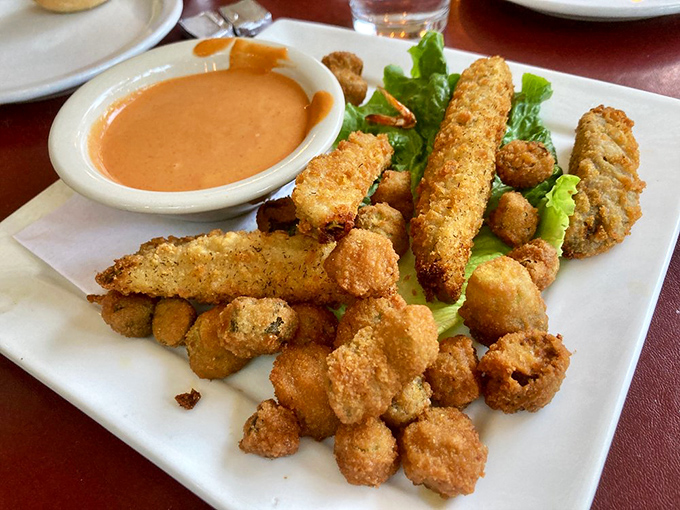 Deep-fried pickles and okra: the appetizer that ruins all future appetizers. Crispy, tangy bites with dipping sauce that makes sharing a moral dilemma.