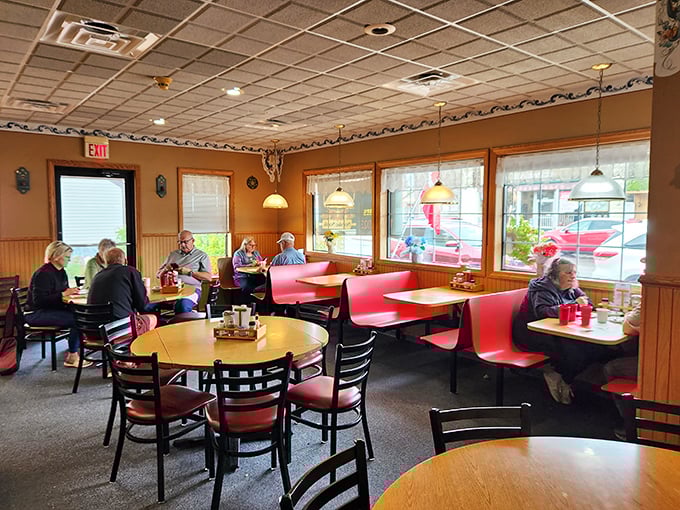 Red booths that have cradled generations of happy diners, witnessing countless first dates, family celebrations, and "I shouldn't, but I will" dessert decisions.