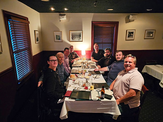 A gathering of friends around a white tablecloth &ndash; the original social network, where notifications come in the form of another round and sharing means passing the bread basket.