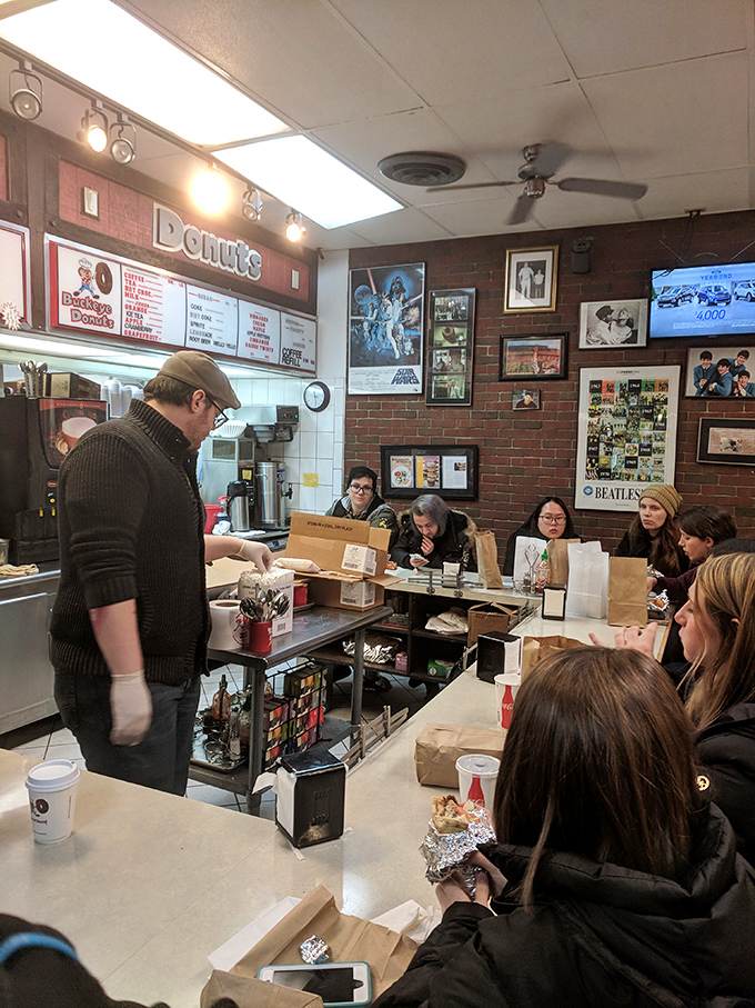 The morning ritual unfolds&mdash;hungry patrons patiently waiting for their turn at the counter while eyeing the donut display with undisguised longing.