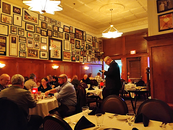The dining room hums with conversation as servers in formal attire navigate between tables with the precision of ballroom dancers.