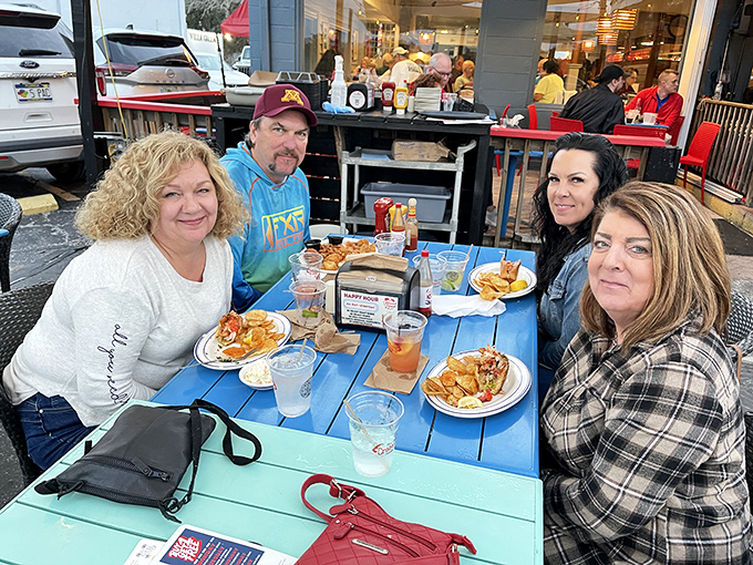A group of happy diners proving that the best seasoning for any meal is good company and the anticipation of Maine lobster.