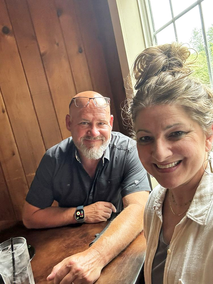 Happy diners in a wood-paneled haven, creating memories that will last far longer than the drive home. Food brings people together.