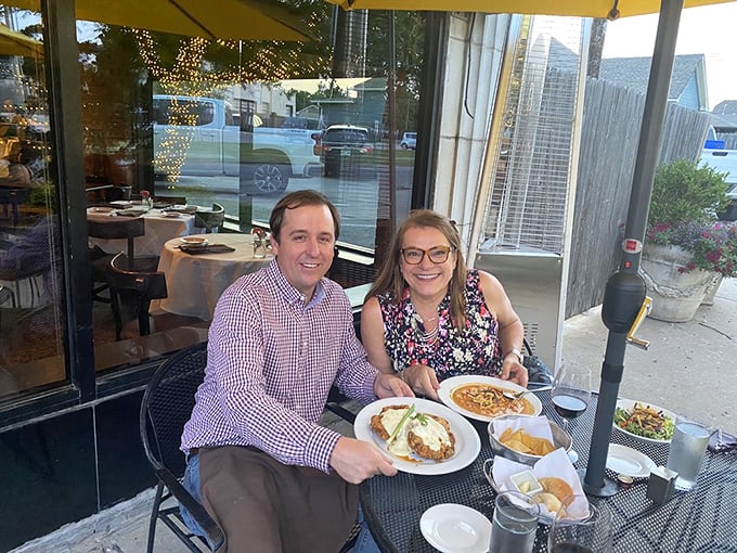 Happy diners proving that good food creates instant joy. Their plates suggest they've made excellent life choices in the last hour.
