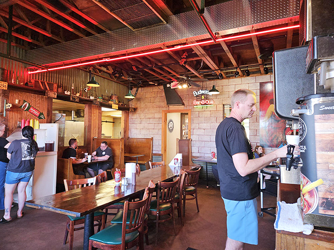 Red neon lighting bathes the dining area in a warm glow that makes everyone look like they're having the best day of their lives.