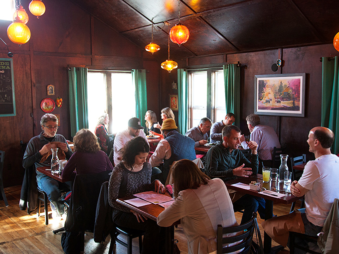 The dining room buzzes with the unmistakable energy of people having genuinely good conversations over genuinely good food. No phones in sight, just people living in the moment.