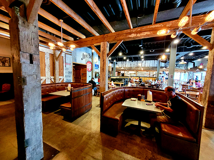 Leather booths cradle diners like a warm hug, while timber beams overhead remind you this is a place that takes its barbecue architecture seriously.