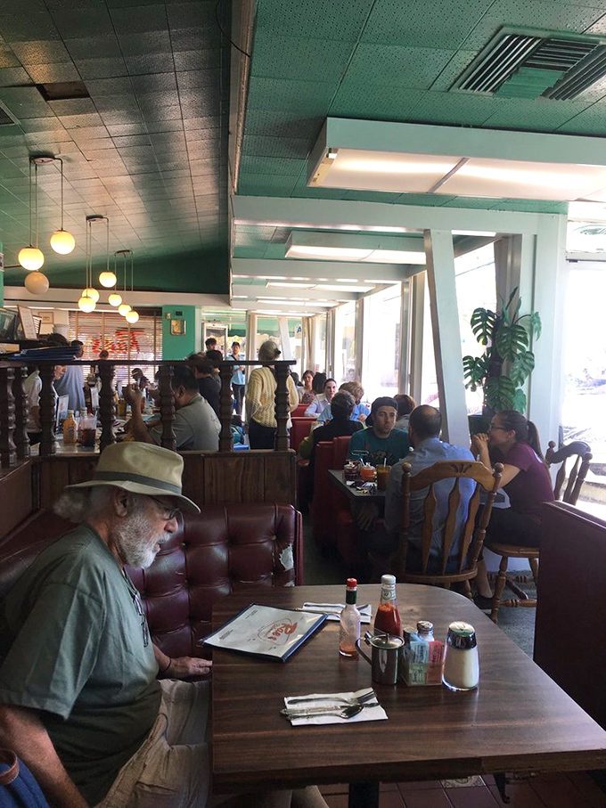 The morning ritual unfolds under spherical lights &ndash; newspapers rustle, coffee steams, and conversations flow as freely as the refills.