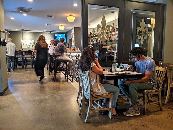 Where strangers become neighbors over shared meals. The fleur-de-lis etched glass dividers whisper New Orleans influence without shouting it.